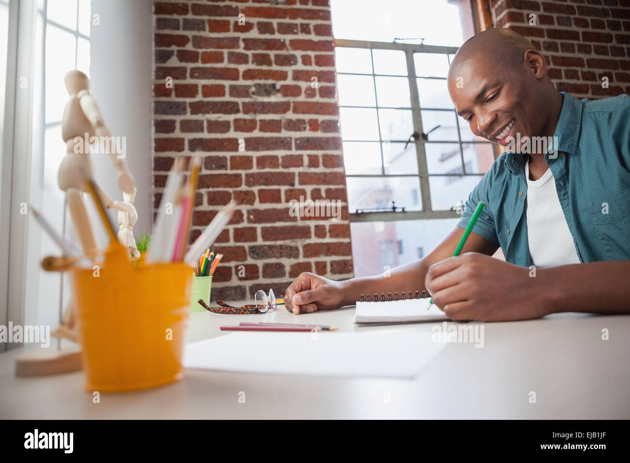 Designer sketching on paper with pencil Stock Photo - Alamy