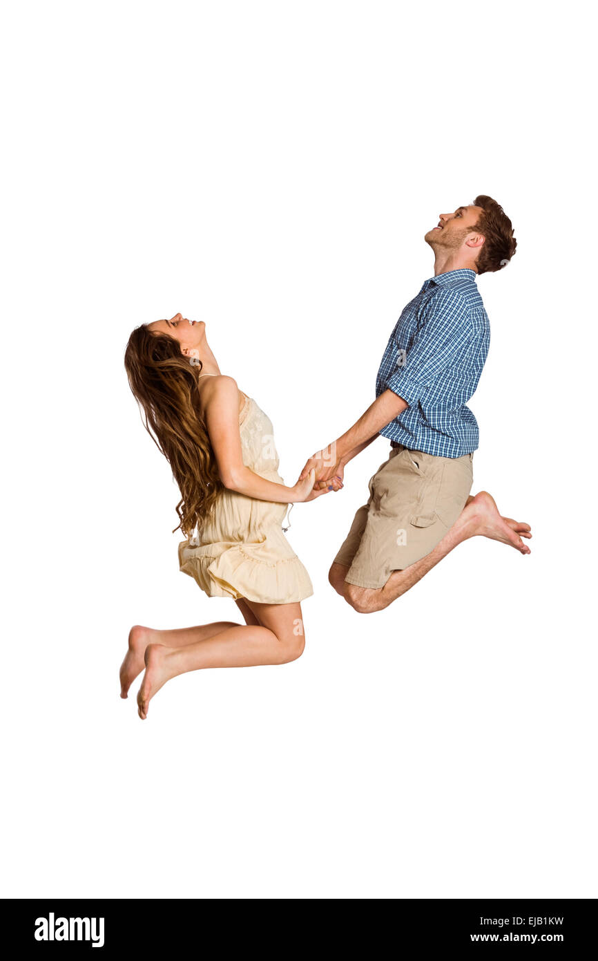 Cheerful young couple jumping Stock Photo - Alamy