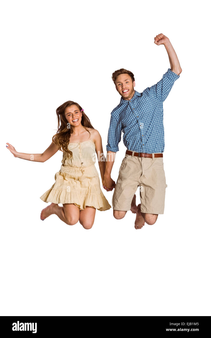 Cheerful young couple jumping Stock Photo - Alamy