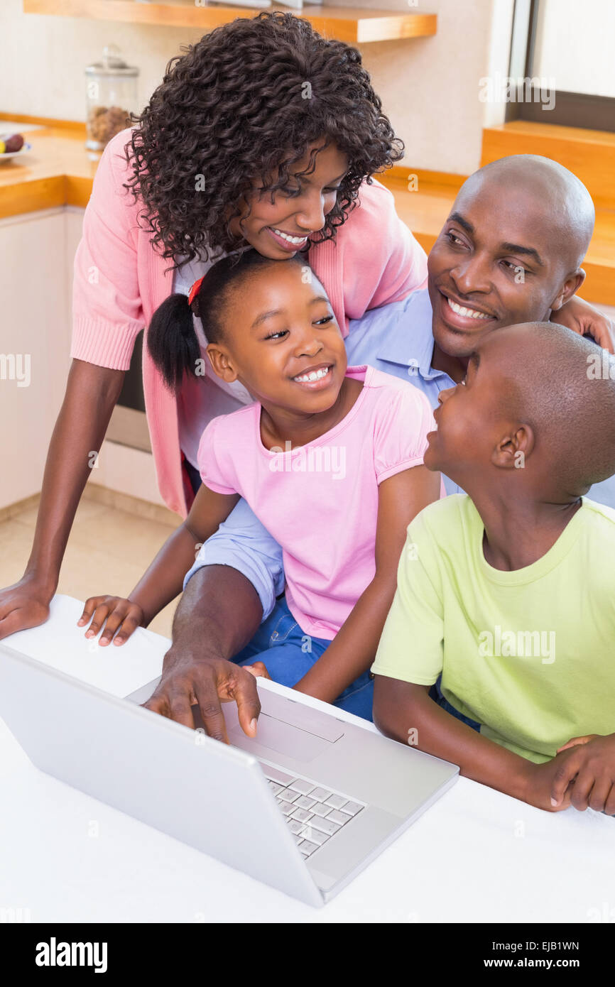 Happy family using the laptop together Stock Photo - Alamy