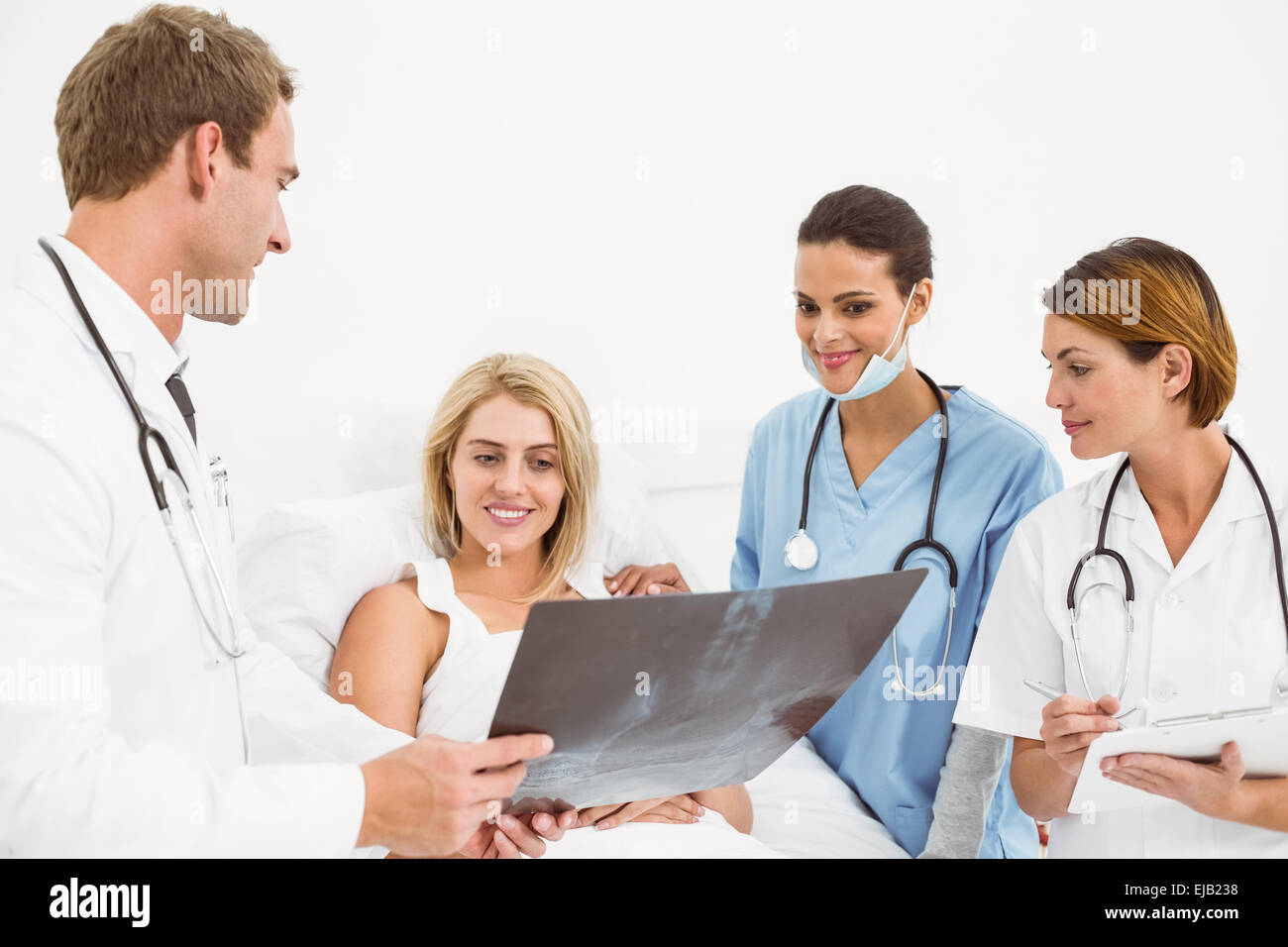 Doctors explaining x-ray to patient Stock Photo - Alamy