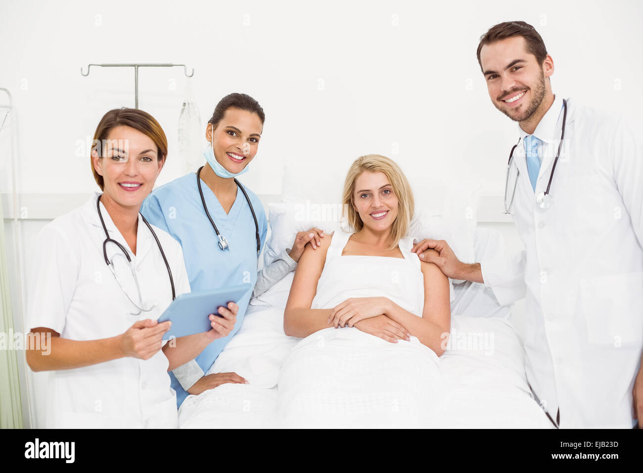 Portrait of doctors visiting patient Stock Photo - Alamy