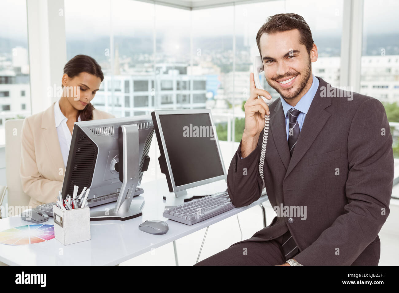 Business people using computers in office Stock Photo - Alamy