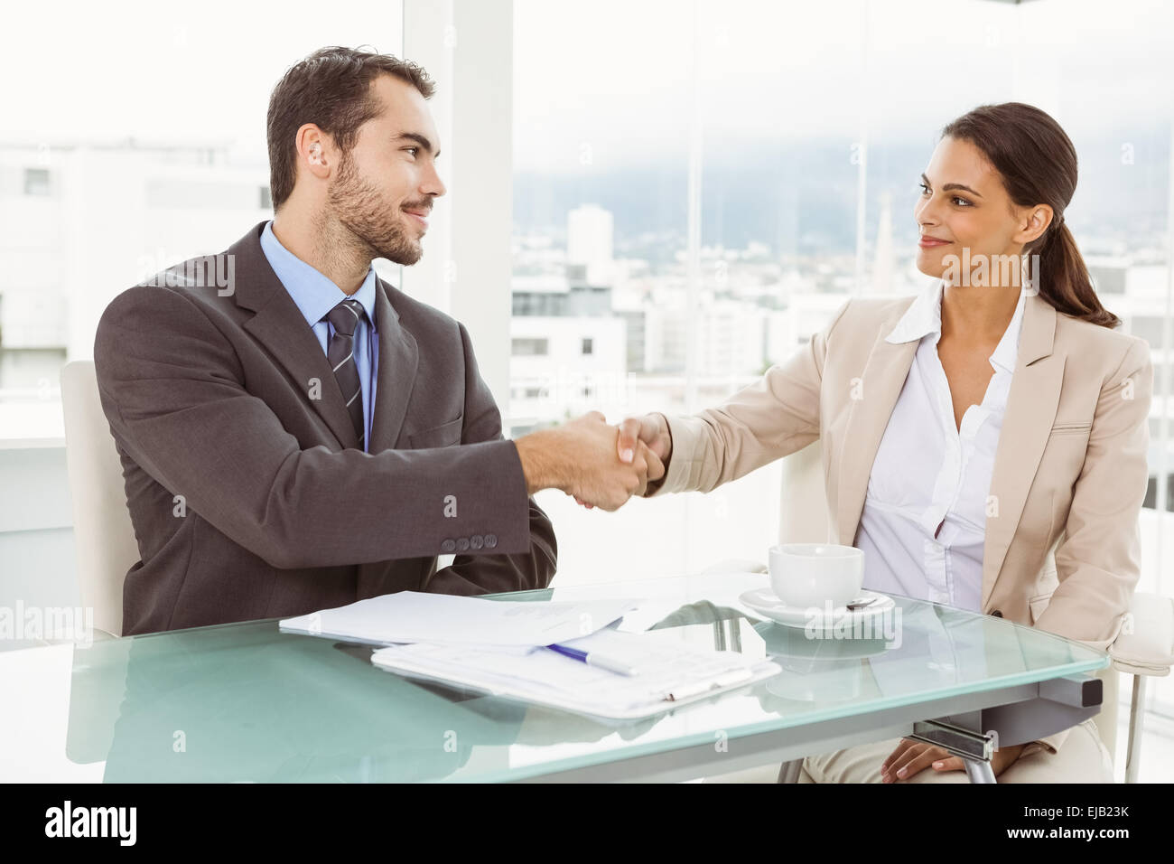 Executives shaking hands in office Stock Photo - Alamy