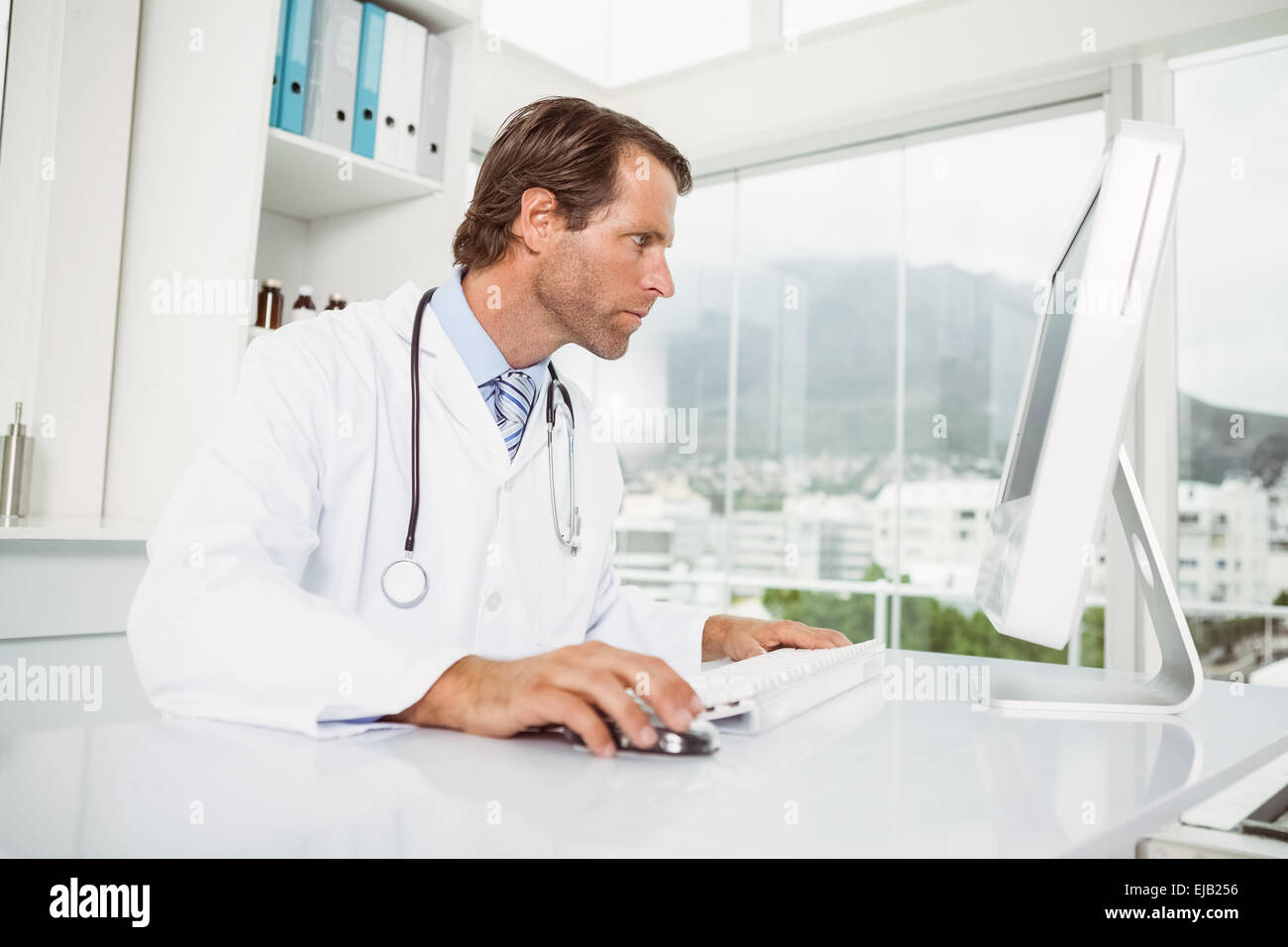 Doctor using computer at medical office Stock Photo - Alamy