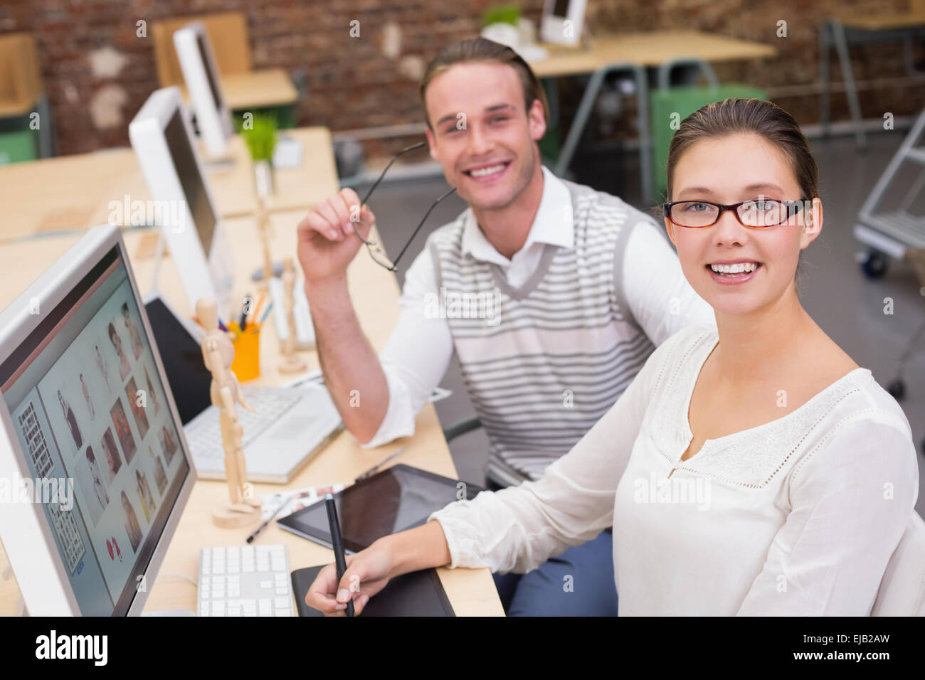 Smiling photo editors in office Stock Photo - Alamy