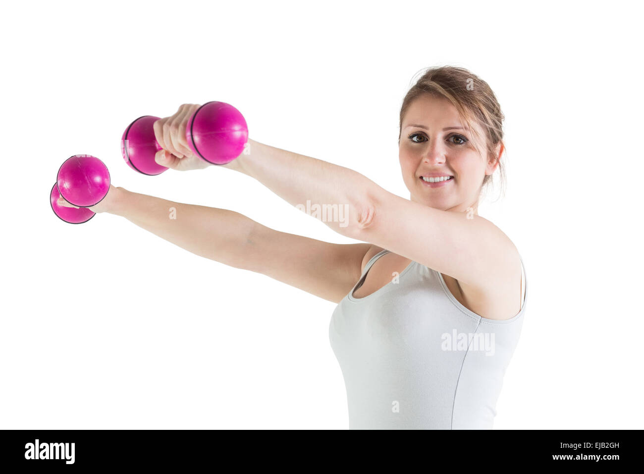 Smiling young woman with dumbbells Stock Photo - Alamy