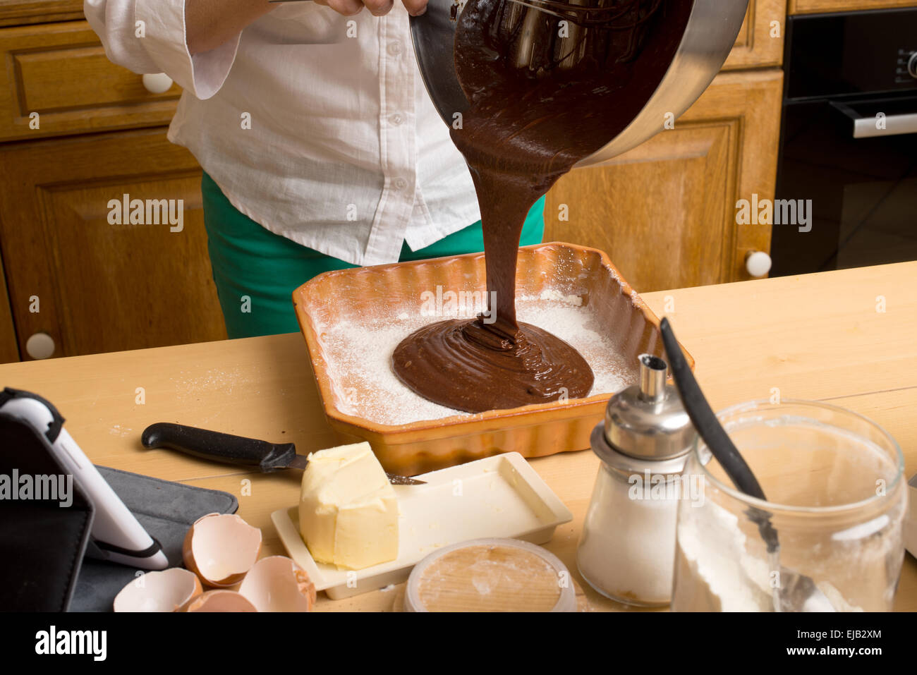 woman hands pouring melted chocolate into a mold Stock Photo - Alamy