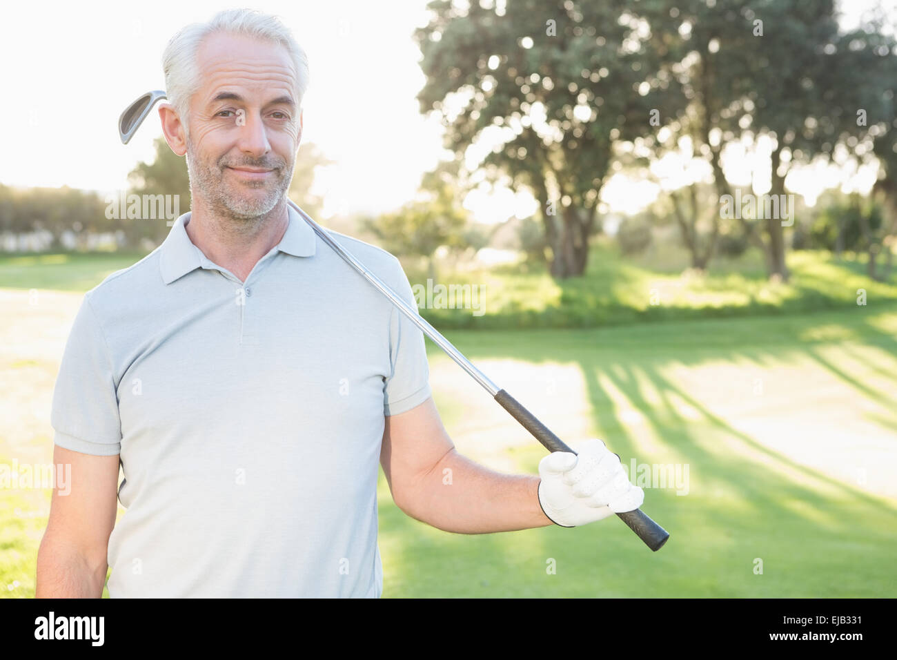 Smiling handsome golfer looking at camera Stock Photo - Alamy