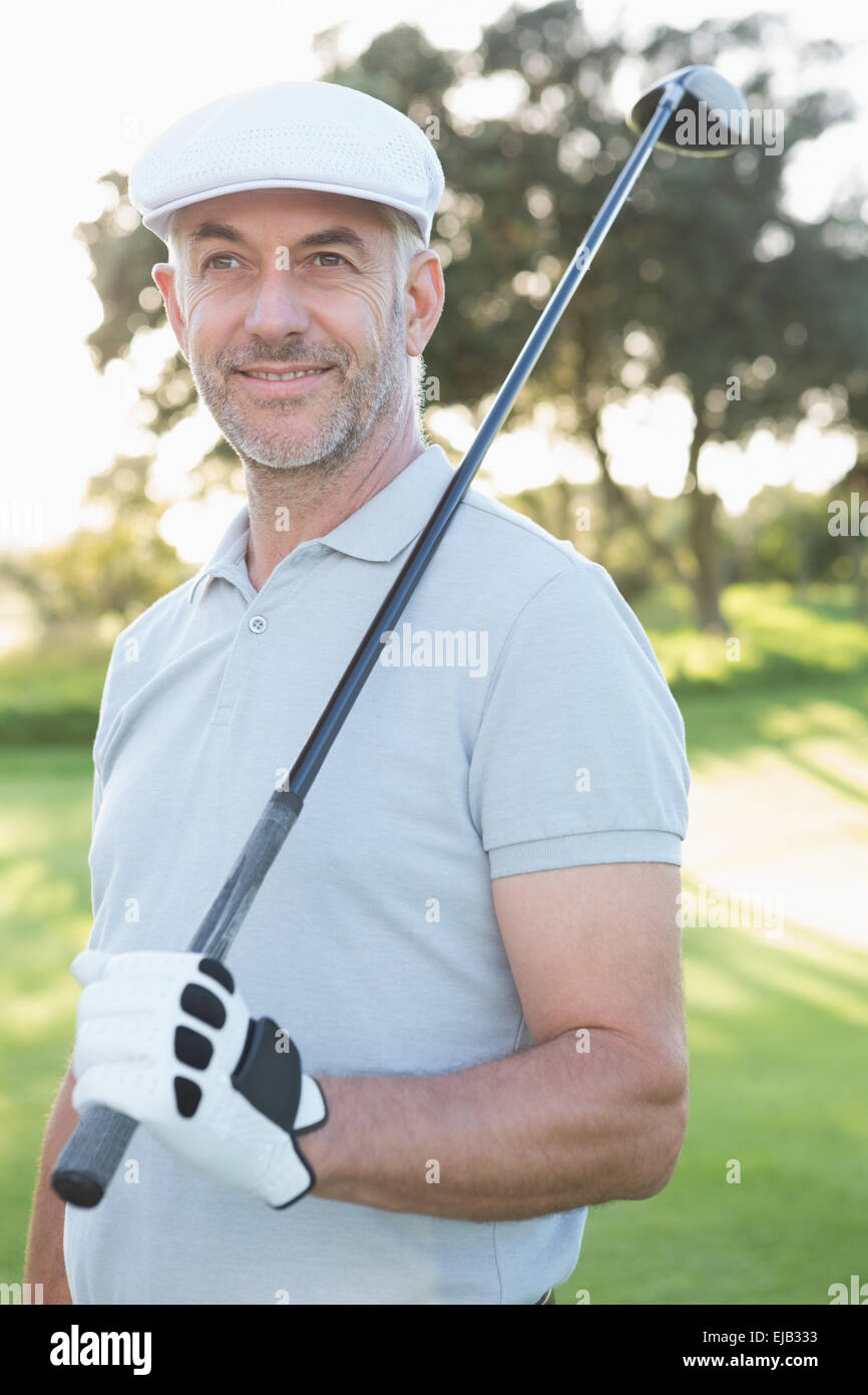 Smiling handsome golfer looking up Stock Photo - Alamy