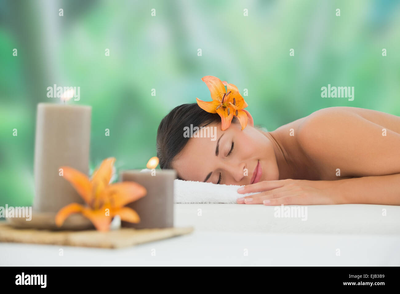 Beautiful brunette relaxing on massage table Stock Photo - Alamy