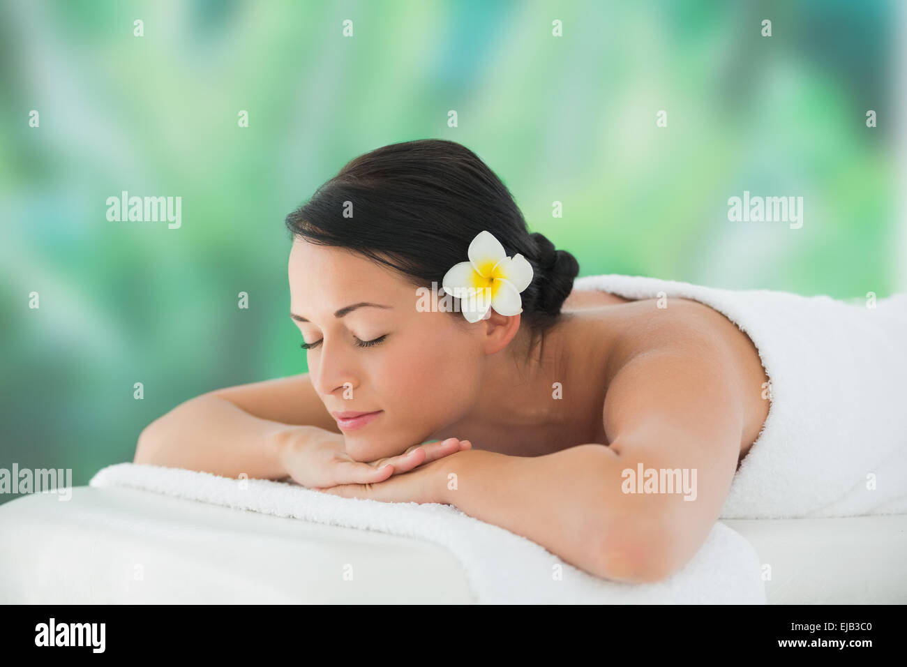 Beautiful brunette relaxing on massage table Stock Photo - Alamy