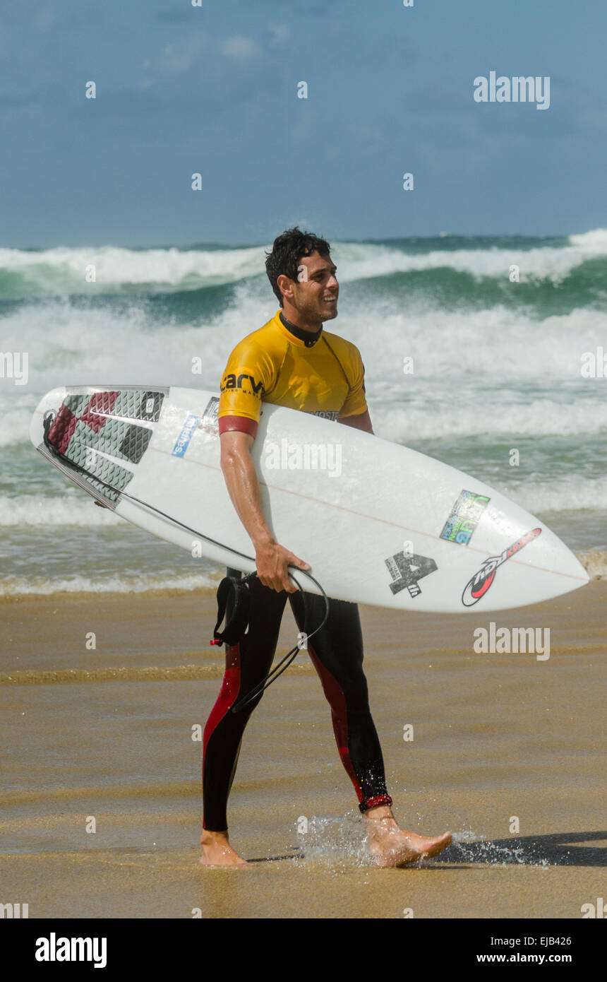 A pro male surfer looking happy after winning his round of the ...