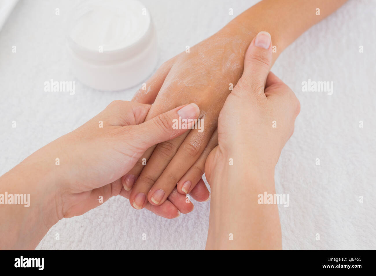 Hands applying cream Stock Photo - Alamy