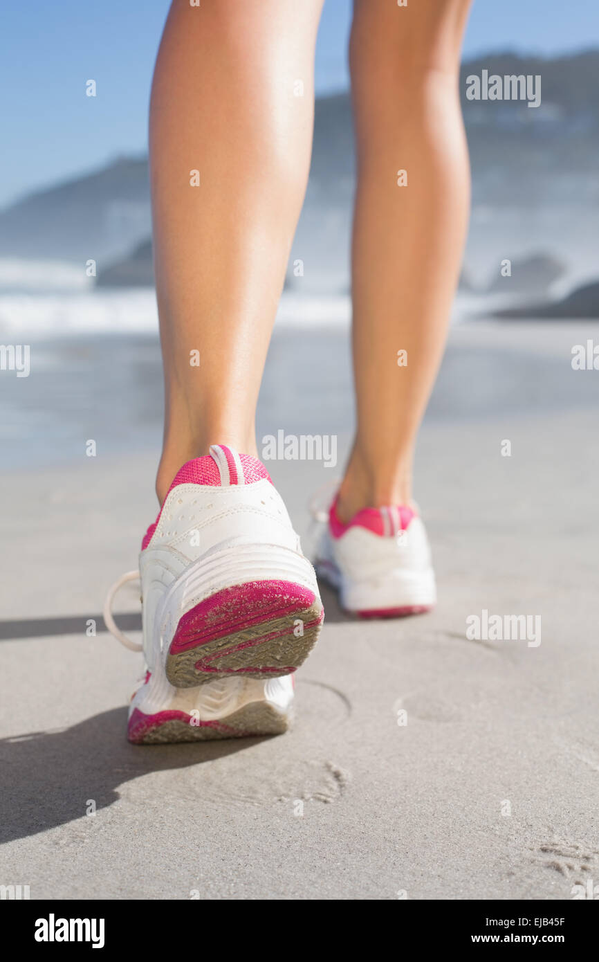 Fit woman walking on the beach Stock Photo - Alamy