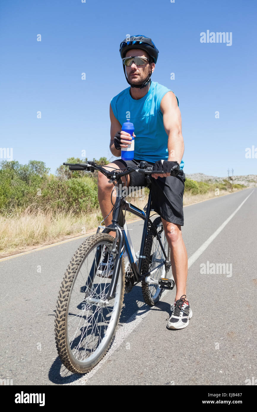 Handsome cyclist taking a break on his bike Stock Photo - Alamy
