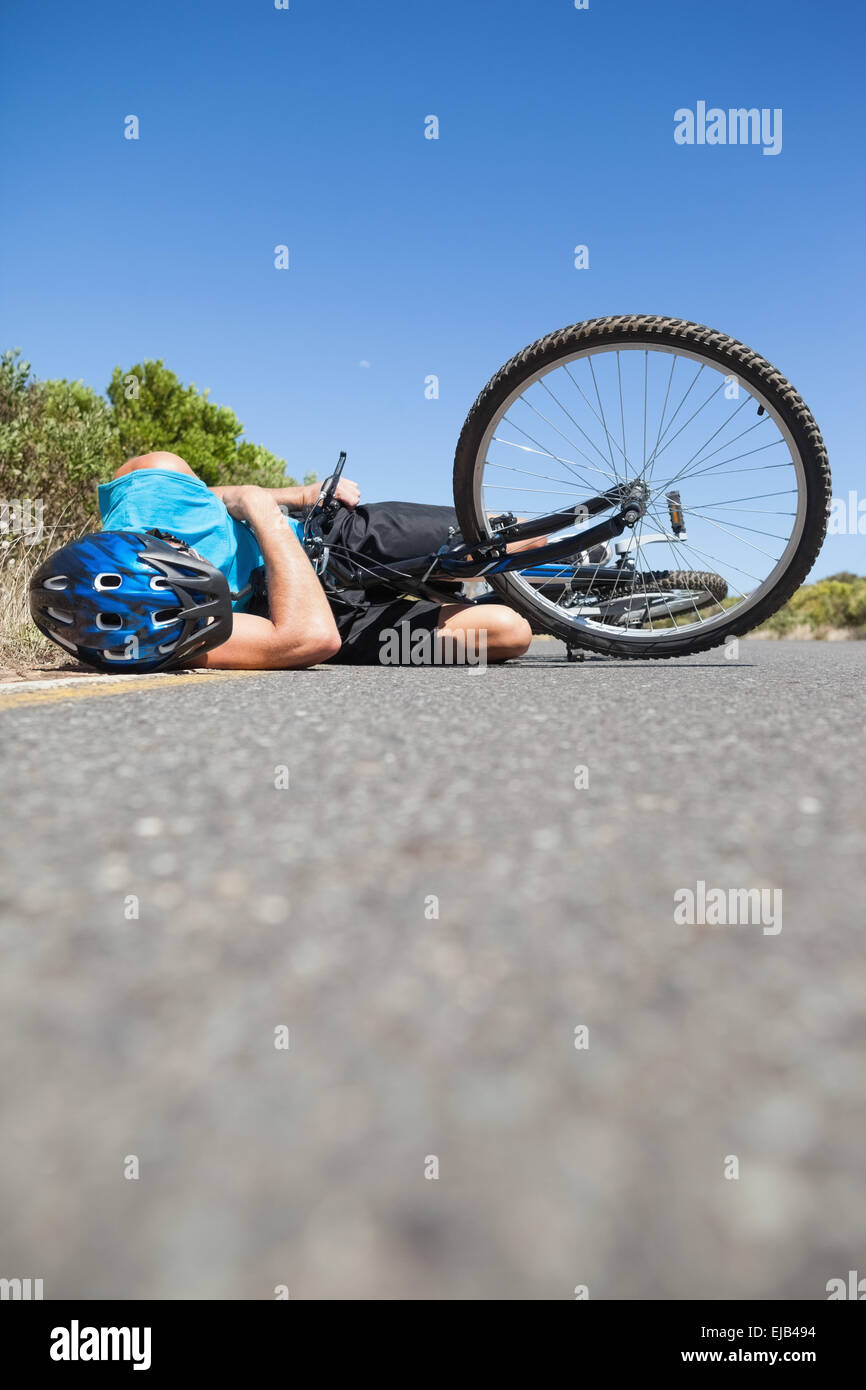 Cyclist lying on the road after an accident Stock Photo - Alamy