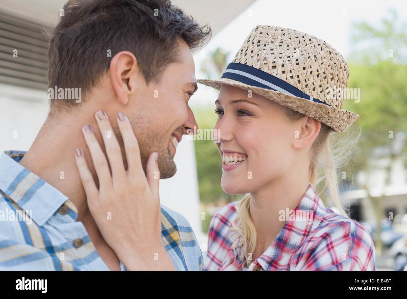 Young hip couple smiling at each other Stock Photo - Alamy