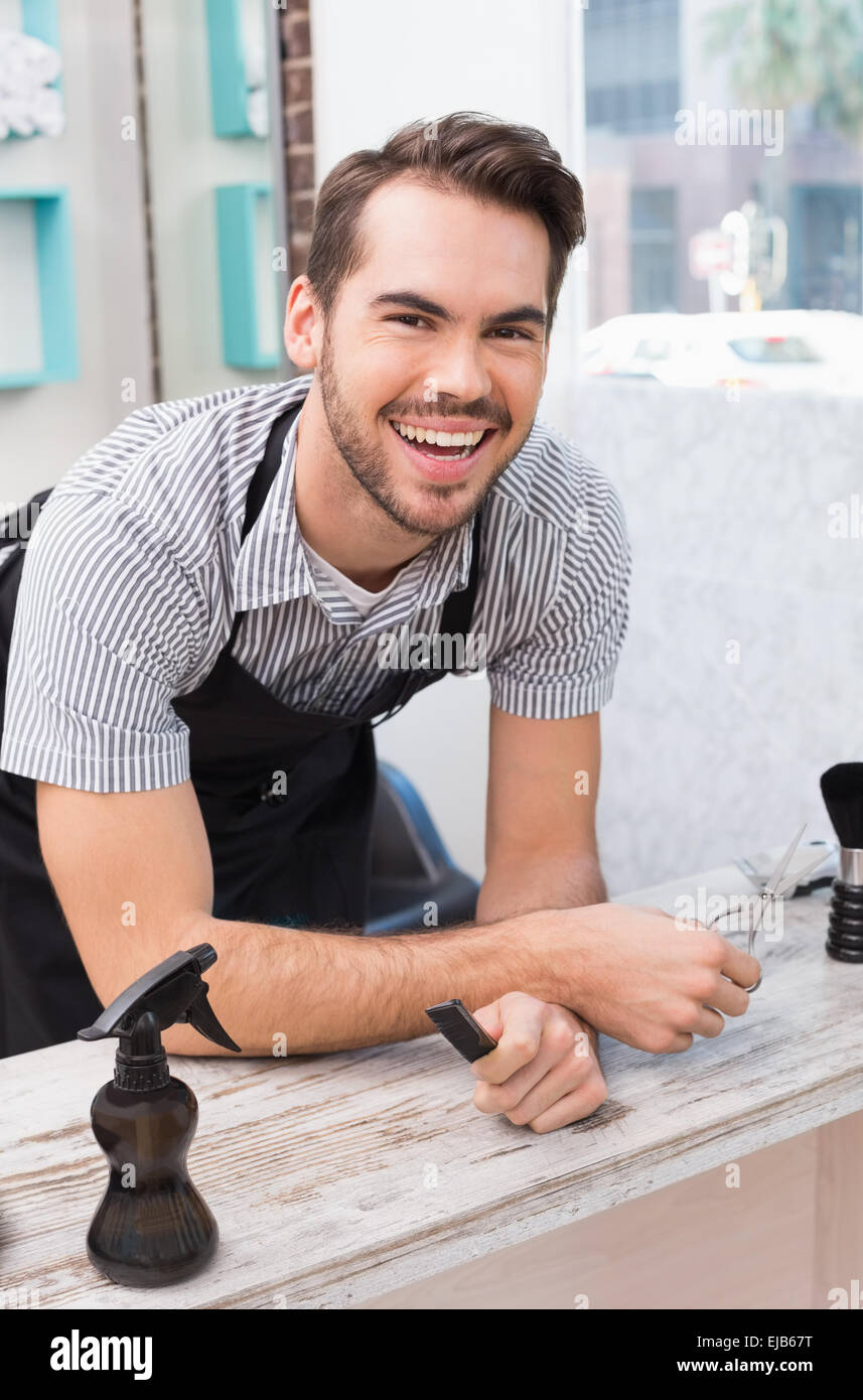 Handsome hair stylist smiling at camera Stock Photo - Alamy