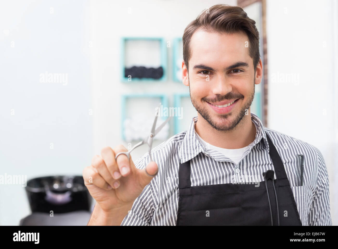 Happy man holding scissors hi-res stock photography and images - Alamy