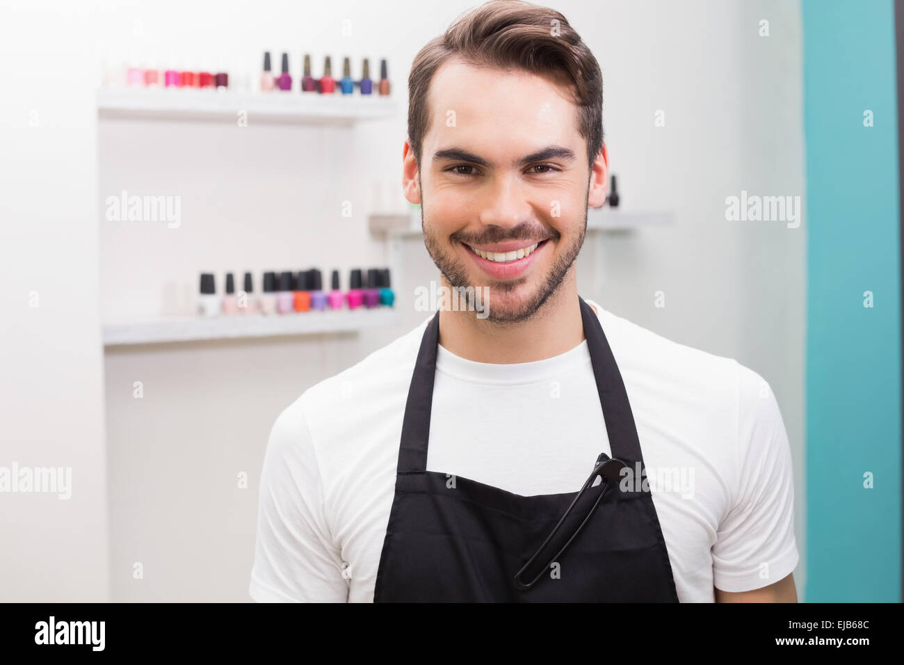 Handsome hair stylist smiling at camera Stock Photo - Alamy