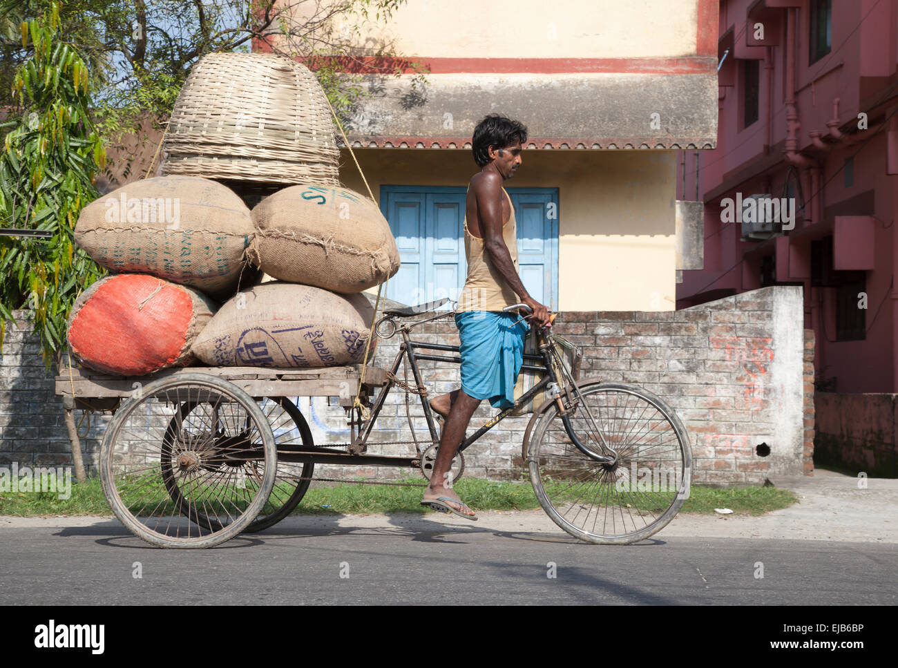 Indian man with loaded cycle rickshaw hi-res stock photography and ...