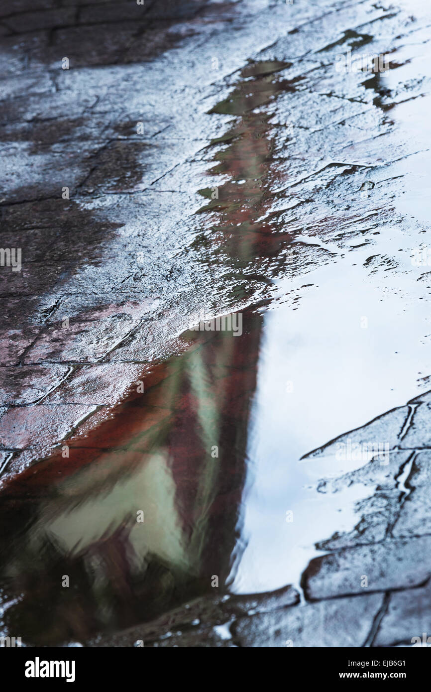 reflected in a rain puddle Stock Photo - Alamy