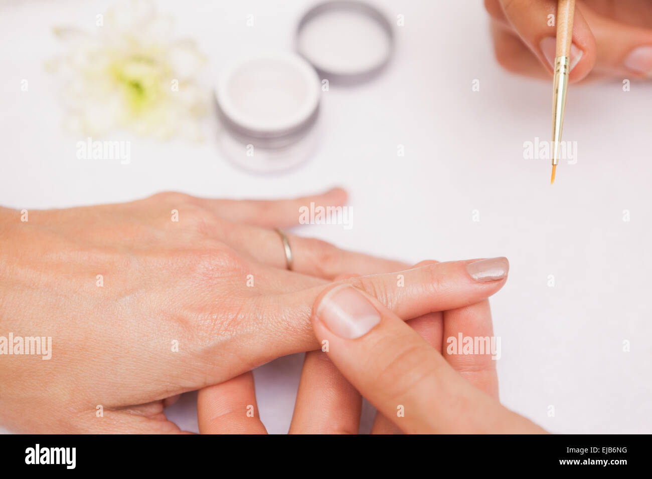 Manicurist painting a customers nails Stock Photo - Alamy