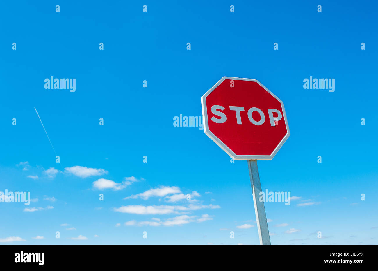Stop sign over blue sky background Stock Photo - Alamy