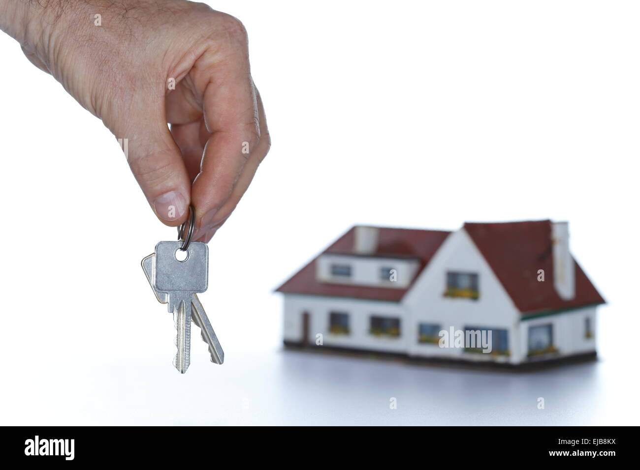 hand with key and house Stock Photo - Alamy