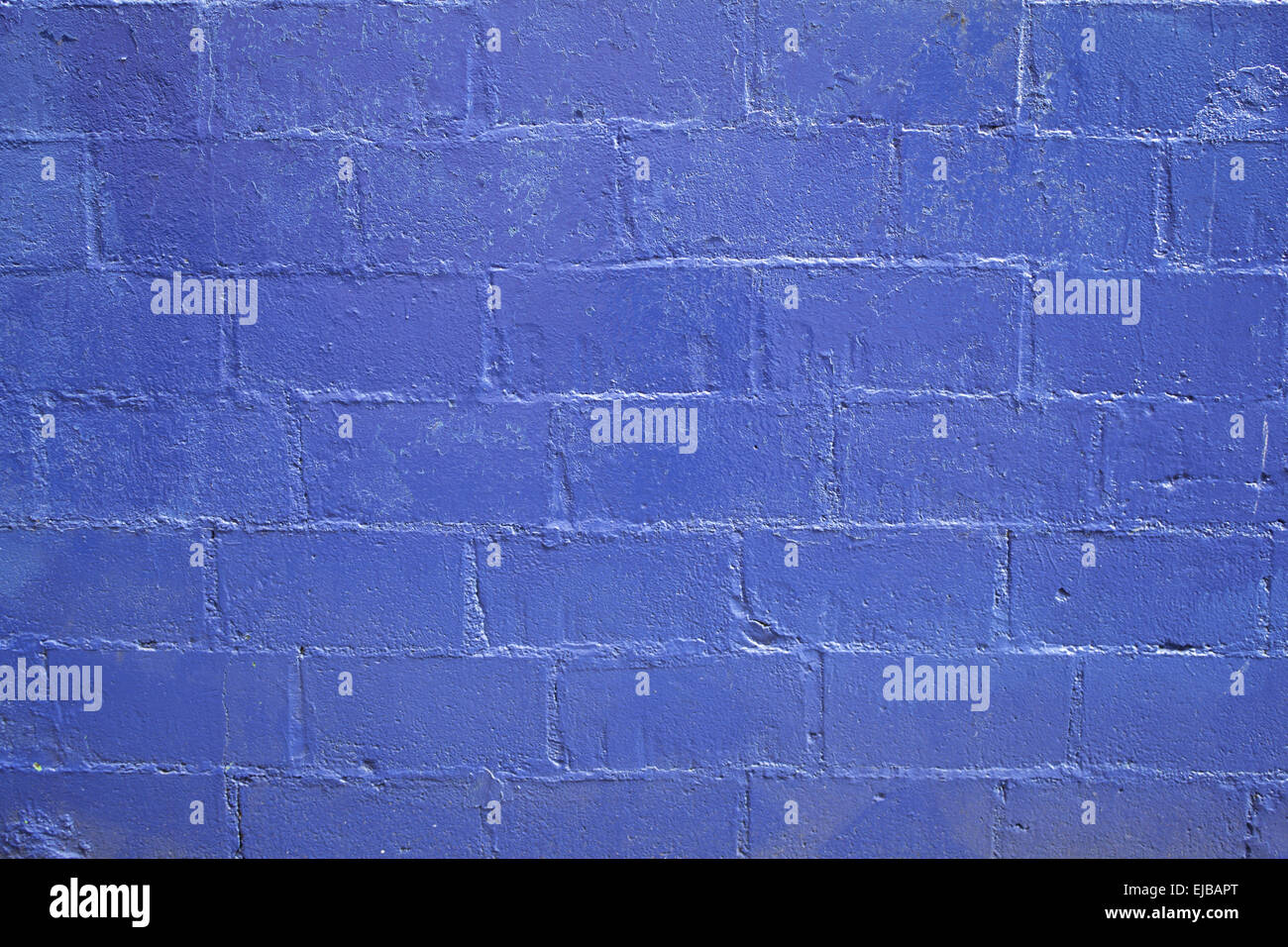 Bright blue bricks on the facade of a building, construction and ...