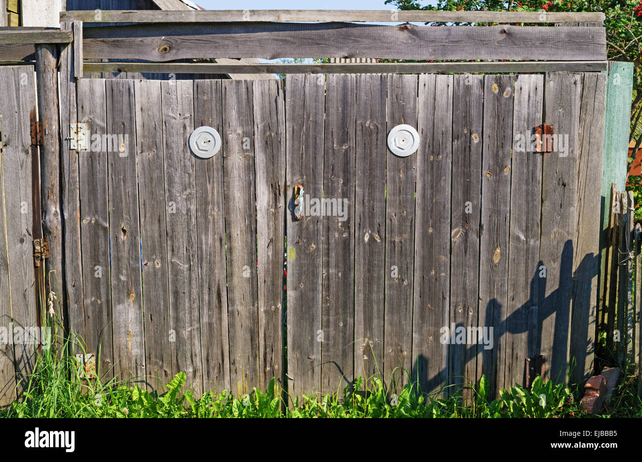 Gray fade wooden house gate doors Stock Photo - Alamy