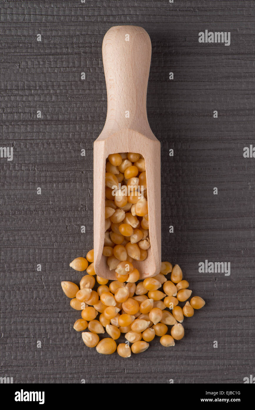 Top view of wooden scoop with corn against grey vinyl background Stock ...
