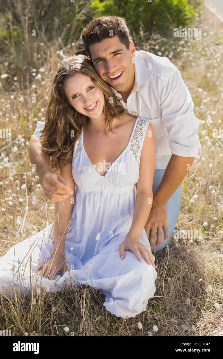 Couple sitting on countryside landscape Stock Photo - Alamy