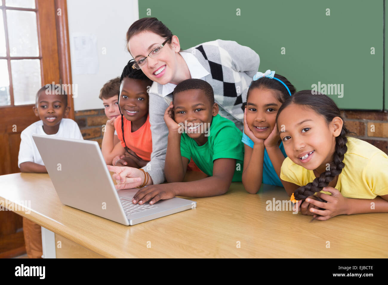 Happy pupils using laptop class hi-res stock photography and images - Alamy
