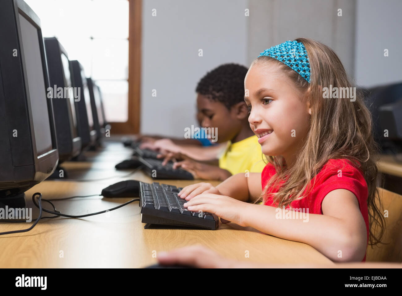 Cute pupils in computer class Stock Photo - Alamy