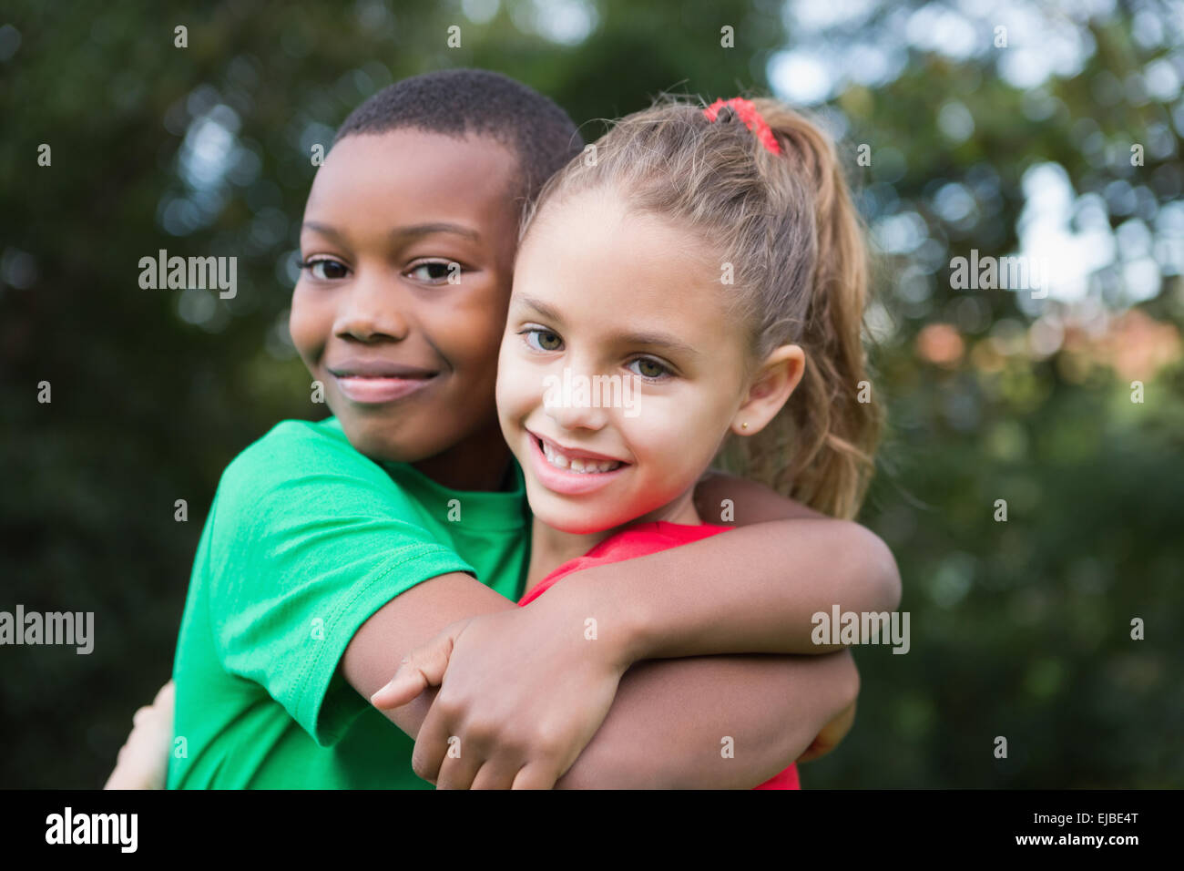 Cute children smiling at camera outside Stock Photo - Alamy
