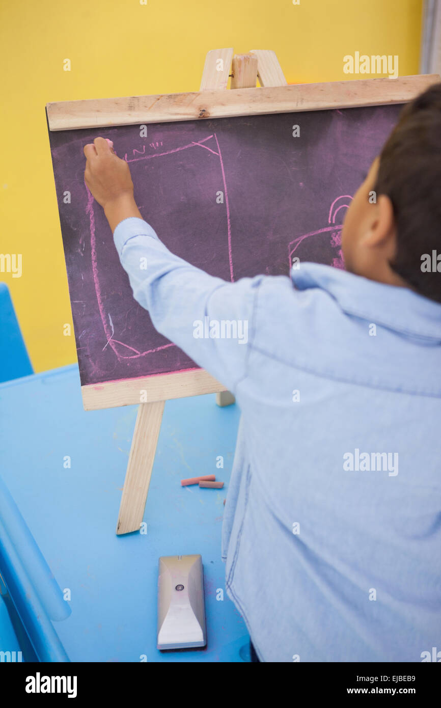 Cute little boy drawing on chalkboard Stock Photo - Alamy