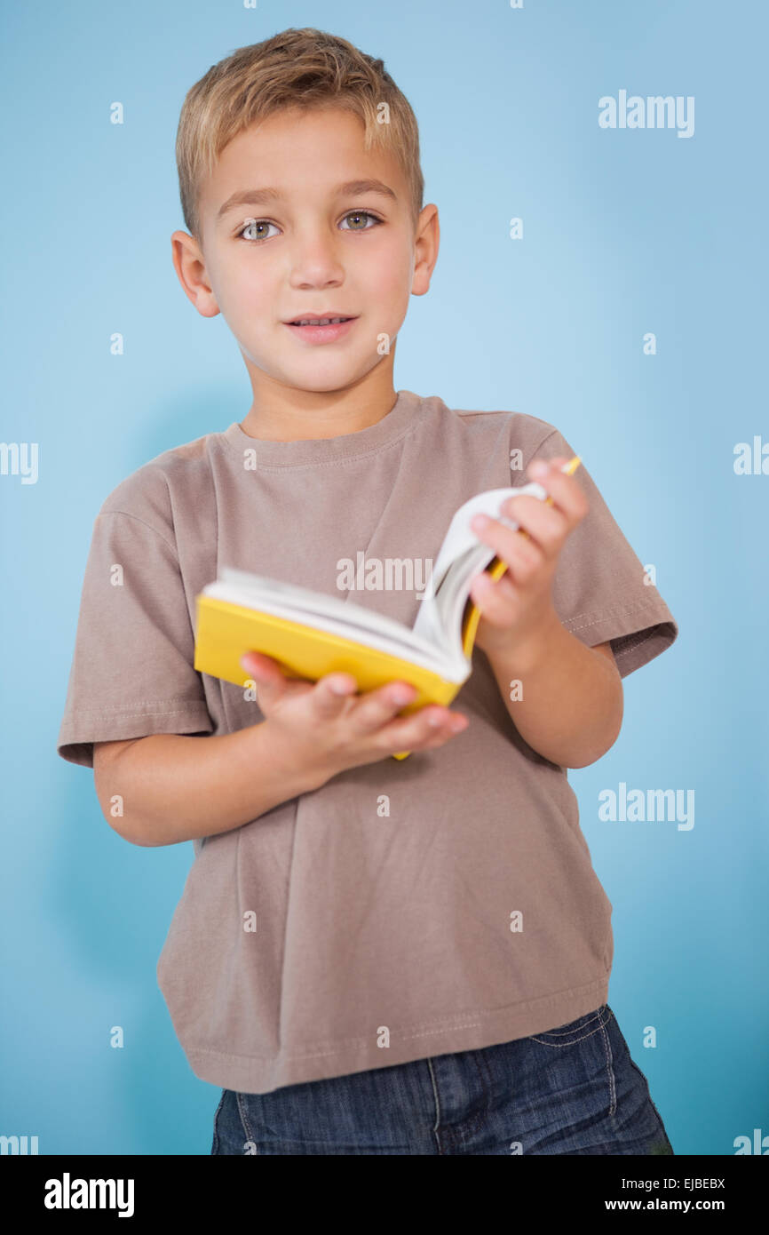 Cute little boy reading in classroom Stock Photo - Alamy