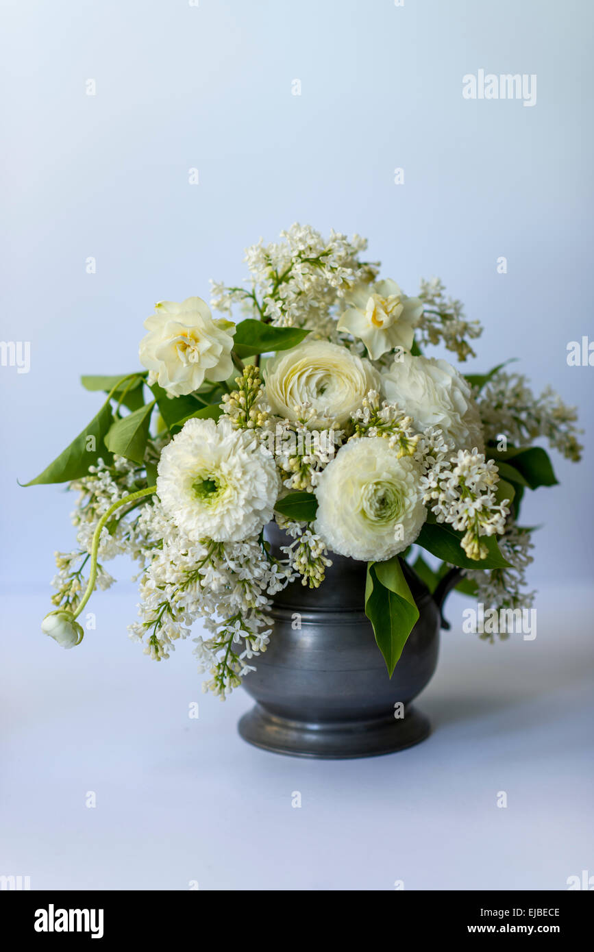 Spring flower arrangement with white ranunculus and lilac blossoms ...