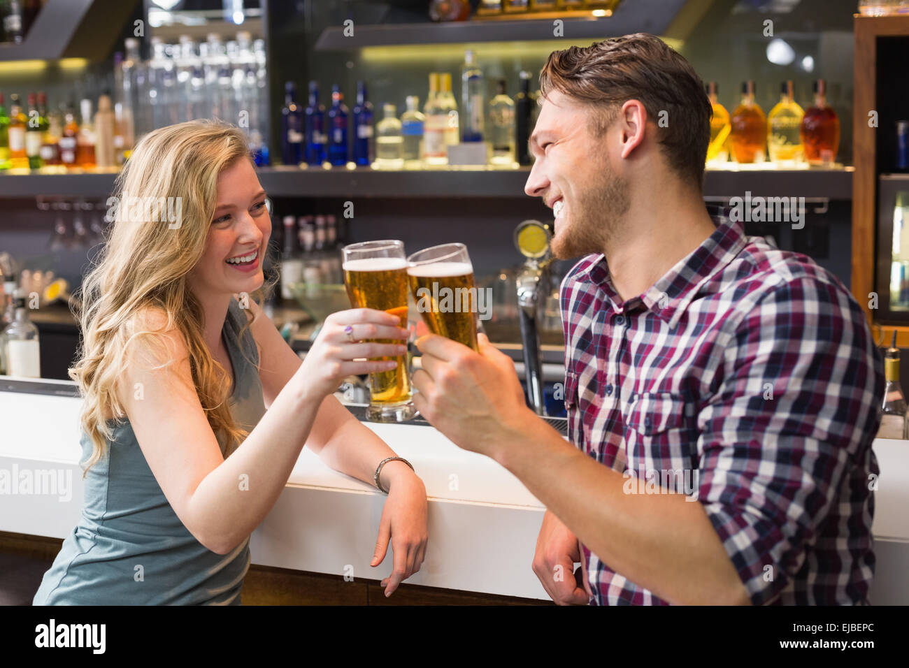 Young couple having a drink together Stock Photo - Alamy