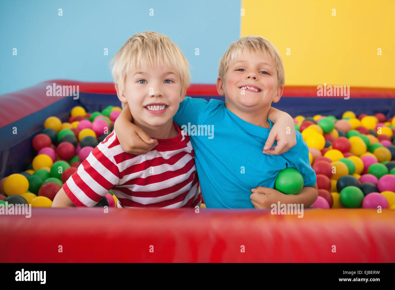 Happy children playing in ball pool Stock Photo - Alamy