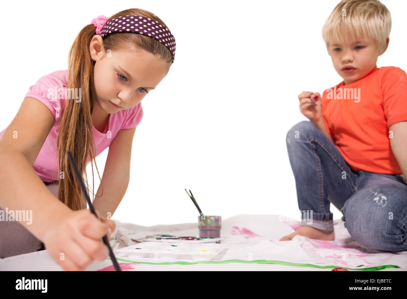 Happy little children painting on the floor Stock Photo - Alamy