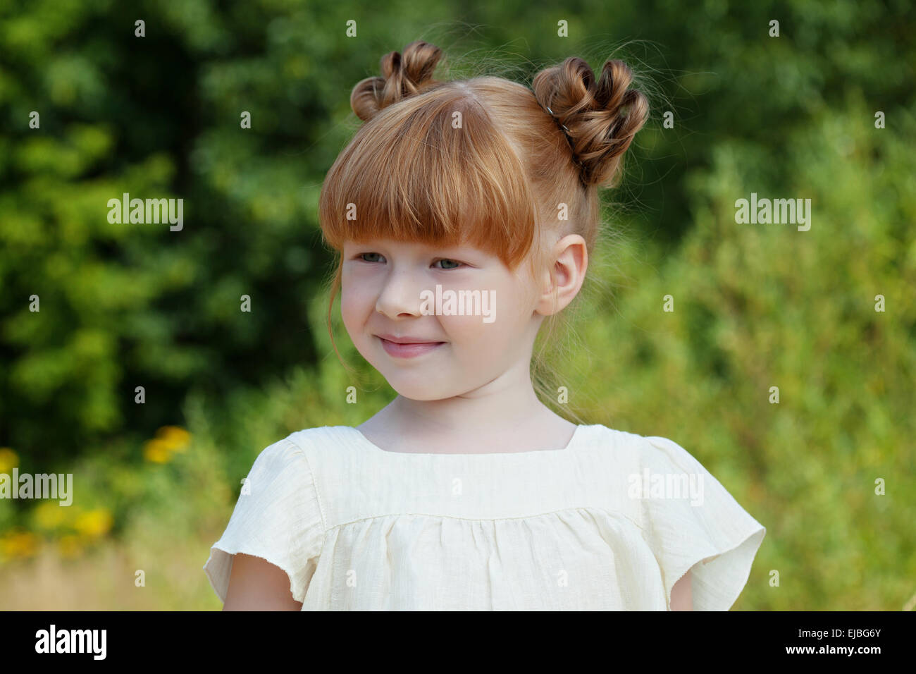 Adorable red-haired girl on green background Stock Photo - Alamy