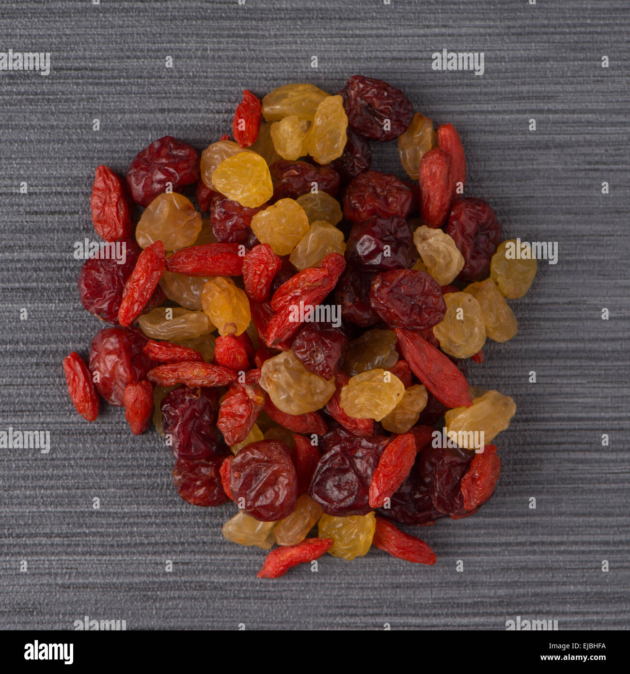 Top view of circle of mixed dried fruits against grey vinyl background ...