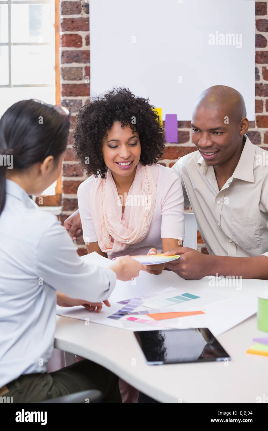 Interior designer speaking with clients Stock Photo - Alamy