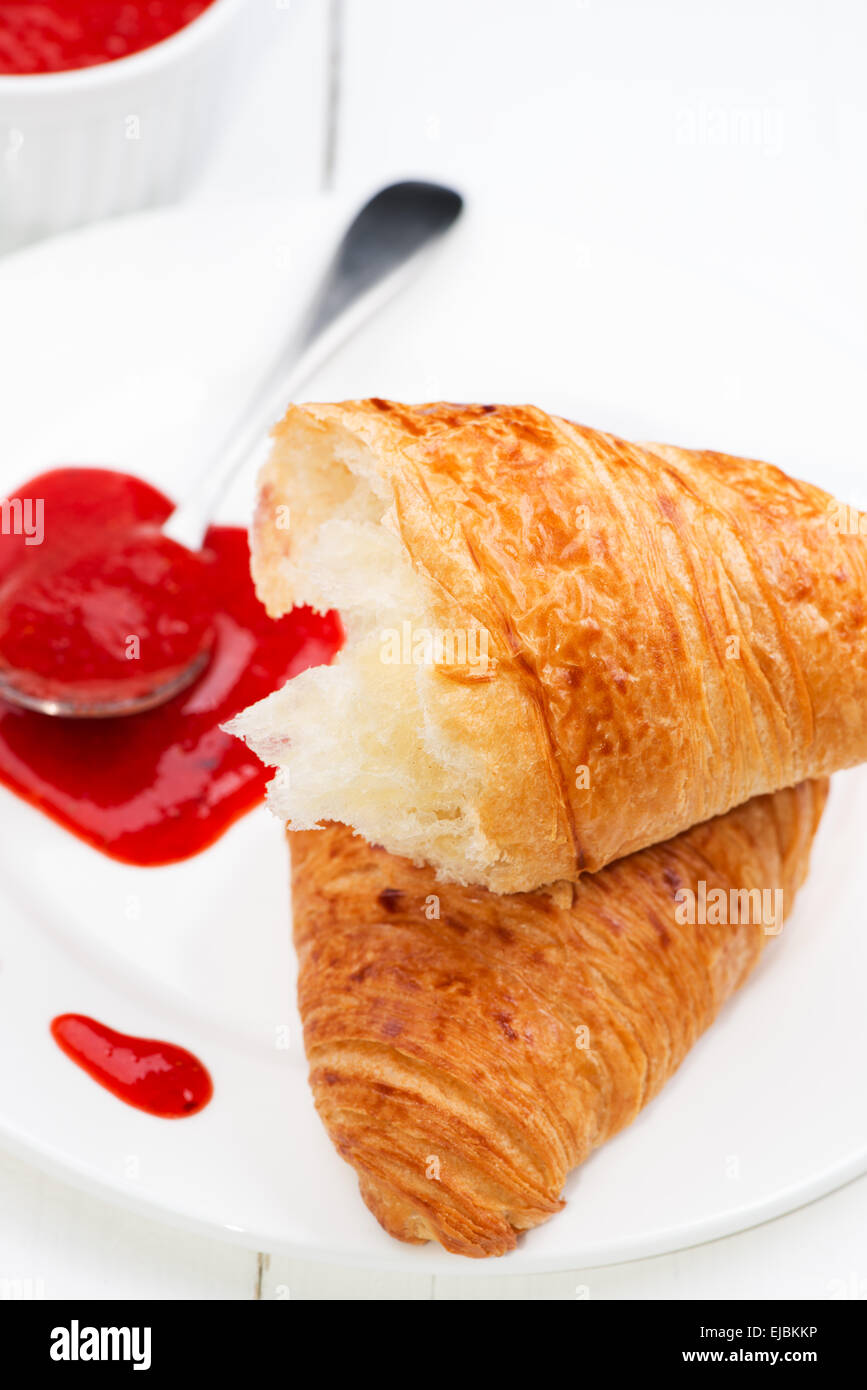 Croissant piece and strawberry jam Stock Photo - Alamy