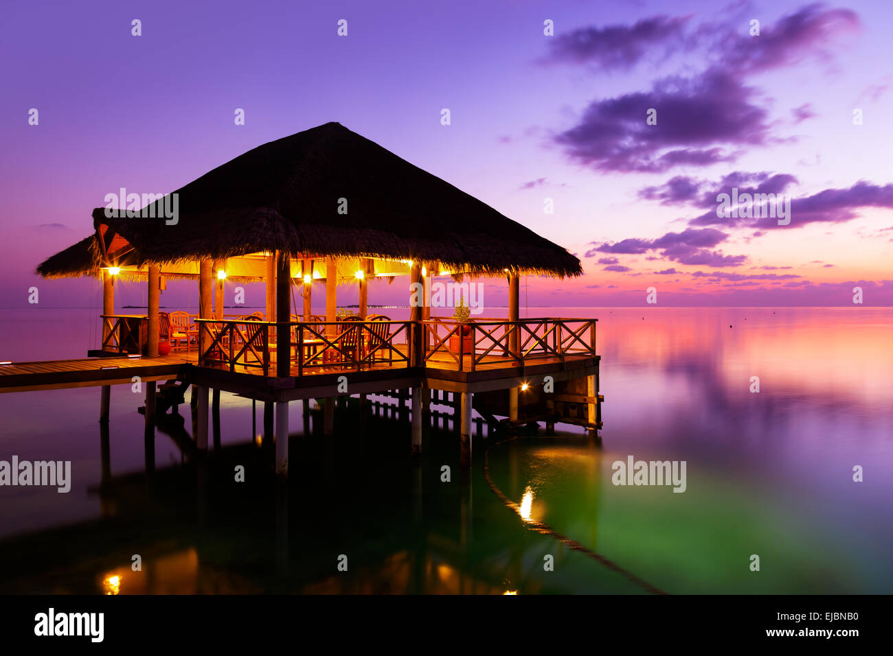 Water cafe at sunset - Maldives Stock Photo - Alamy