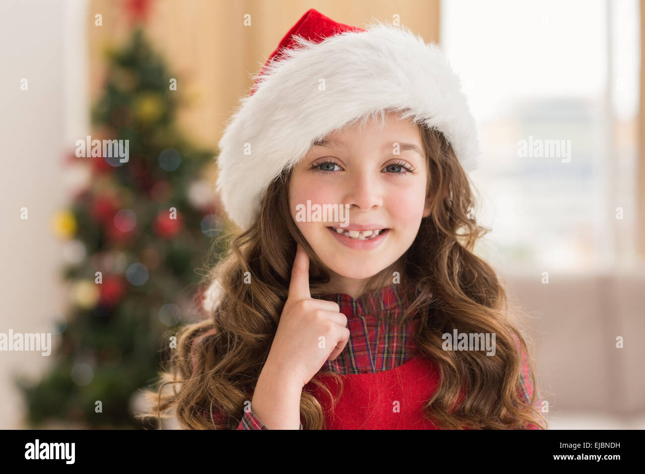 Festive little girl thinking and smiling Stock Photo - Alamy
