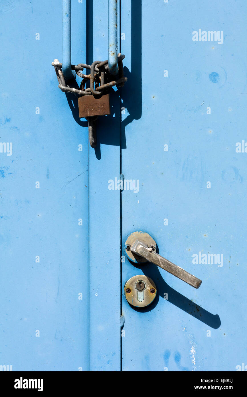 Blue locked door Stock Photo - Alamy